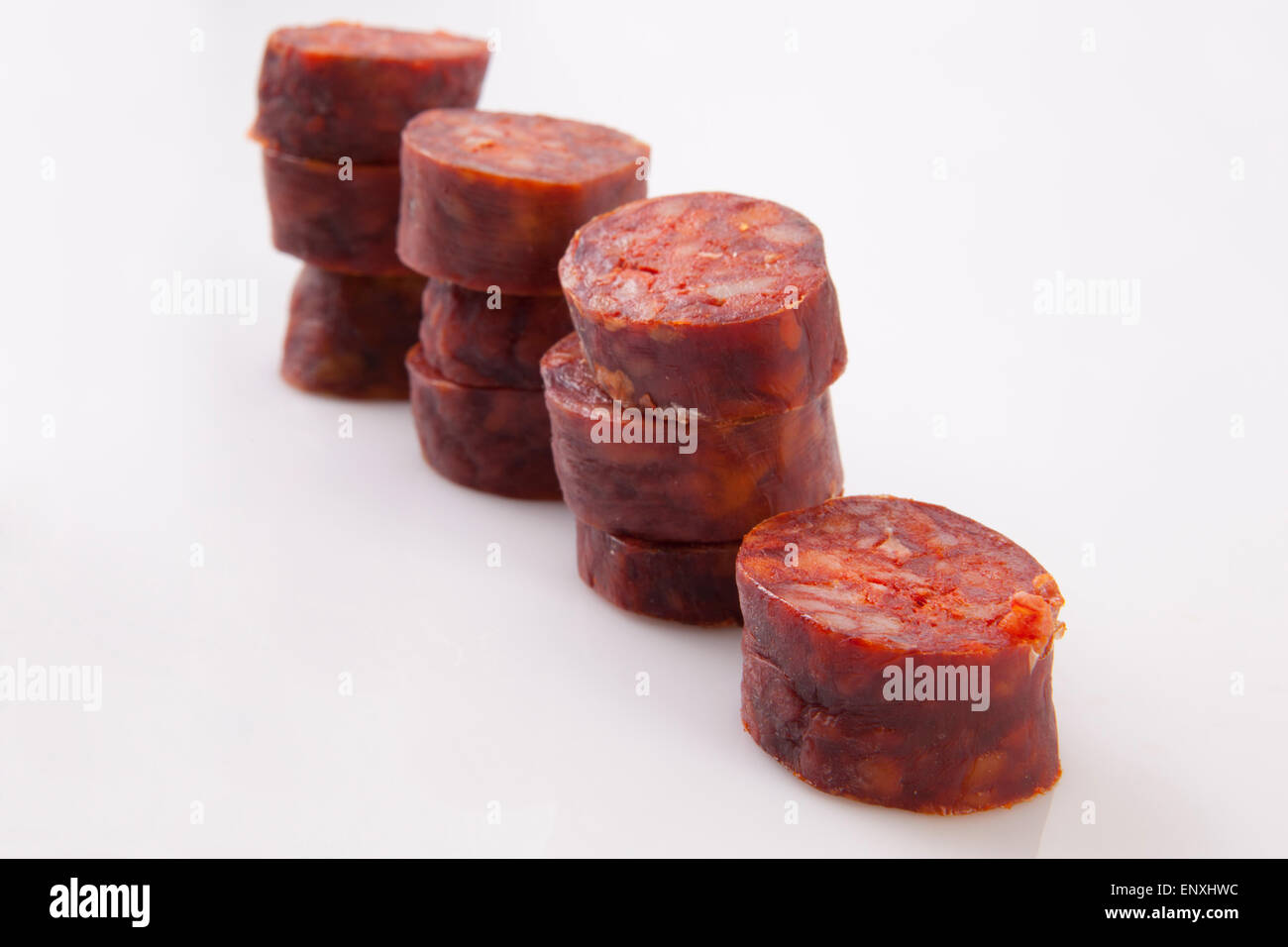 Some cut pieces of red iberian chorizo. Isolated over white background ...