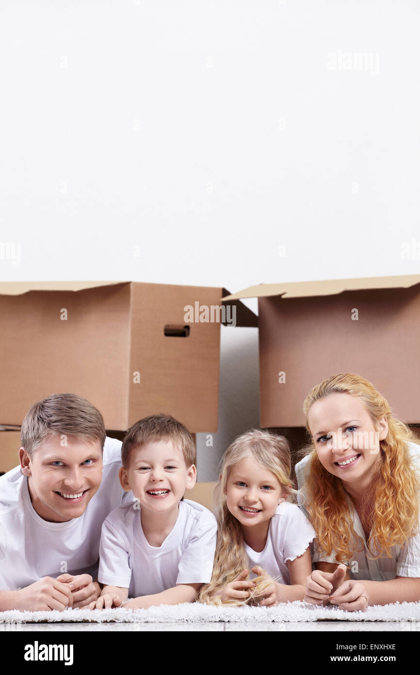 Smiling family on a background of cardboard boxes Stock Photo - Alamy