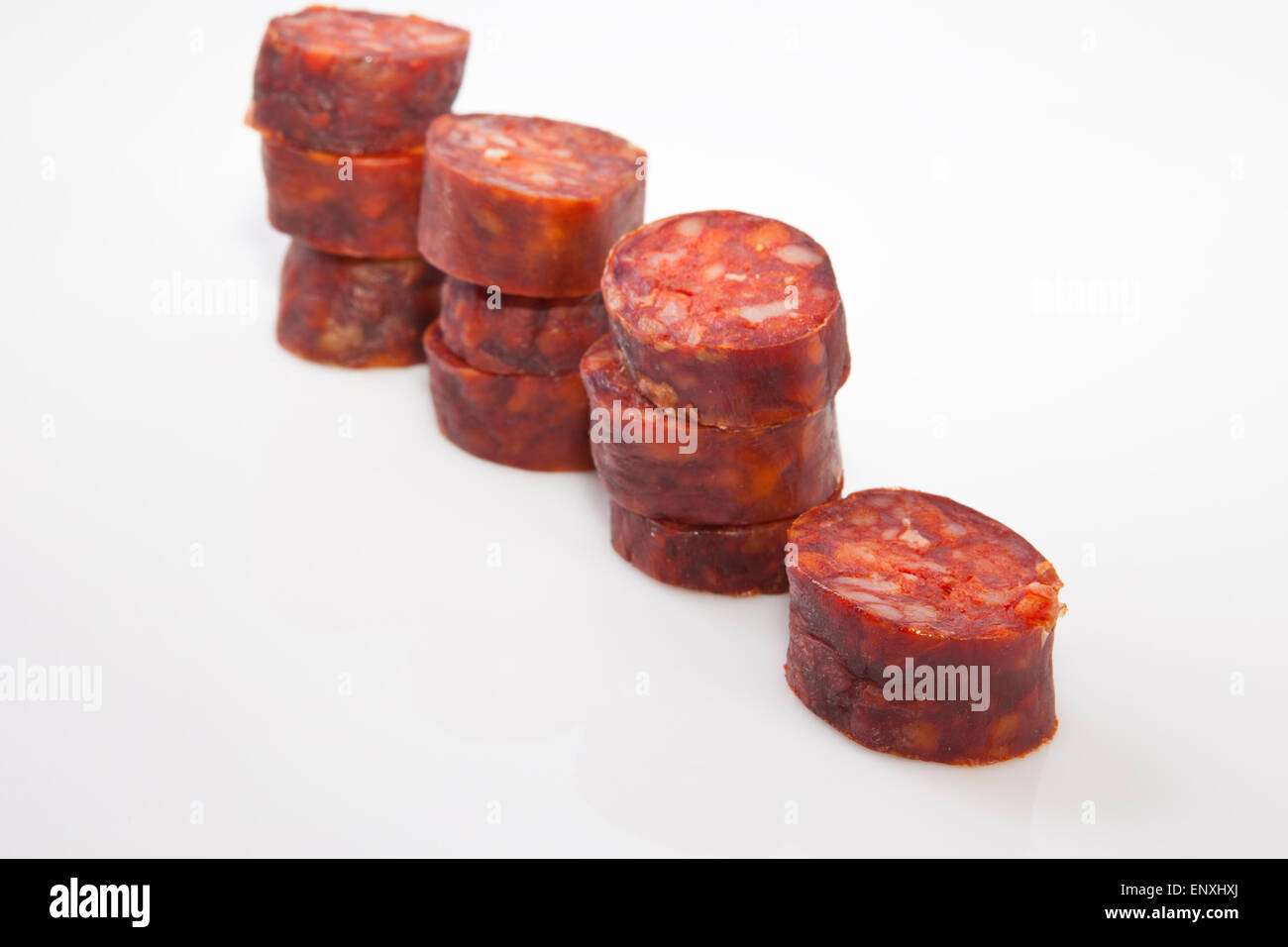 Some cut pieces of red iberian chorizo. Isolated over white background ...
