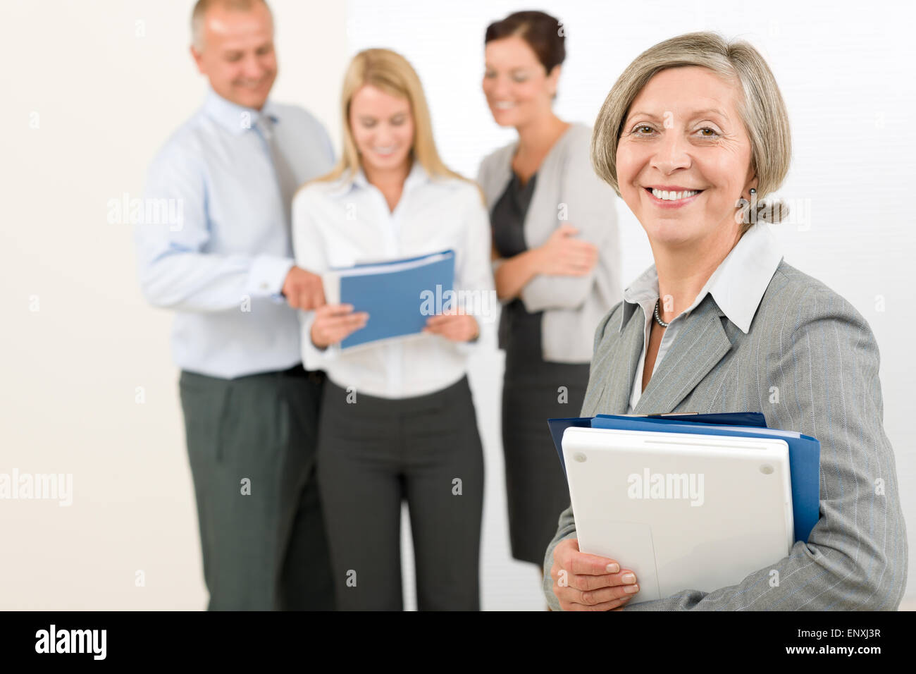 Business team senior woman with happy colleagues Stock Photo - Alamy