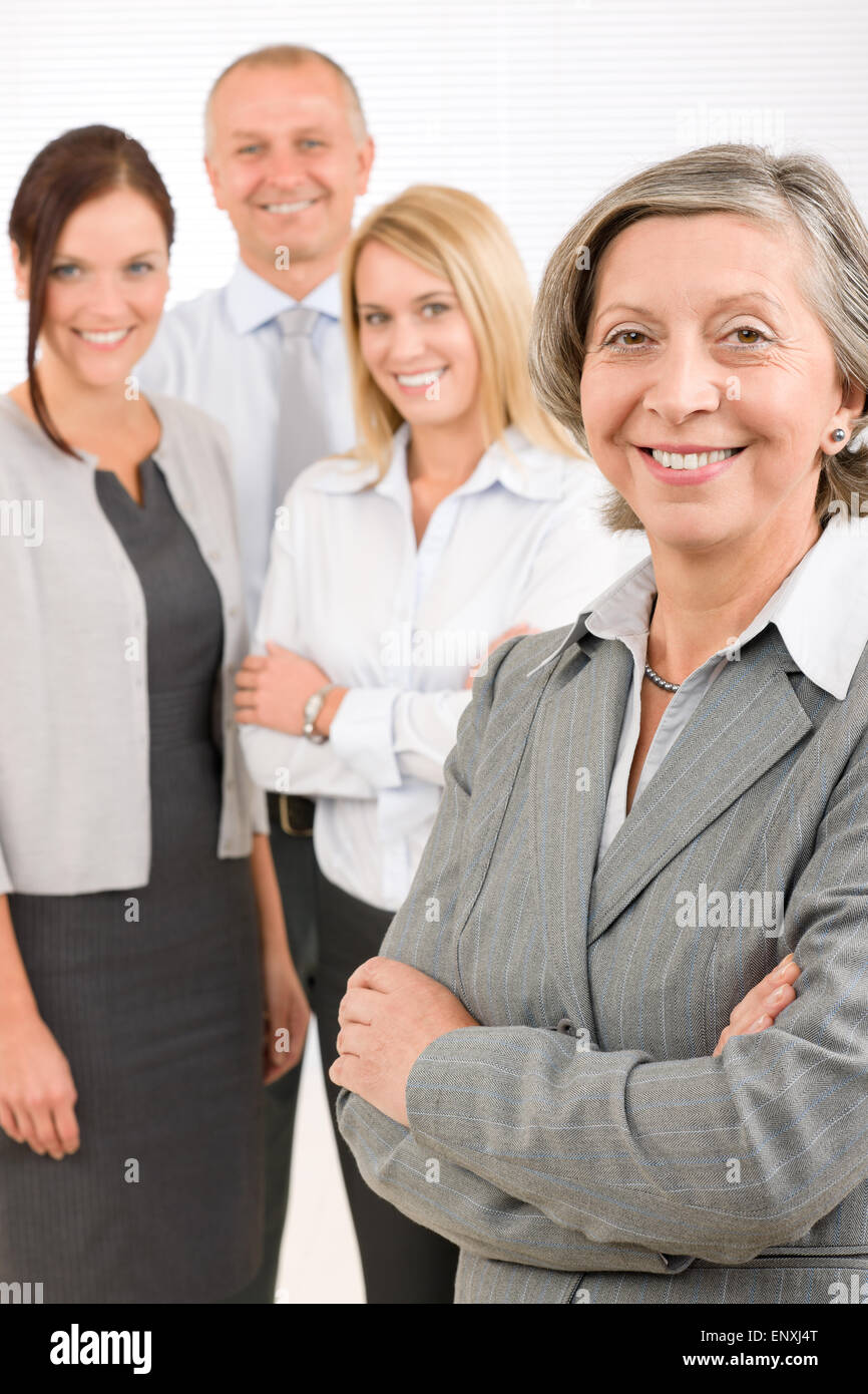 Businesswoman senior with colleagues in the back Stock Photo - Alamy
