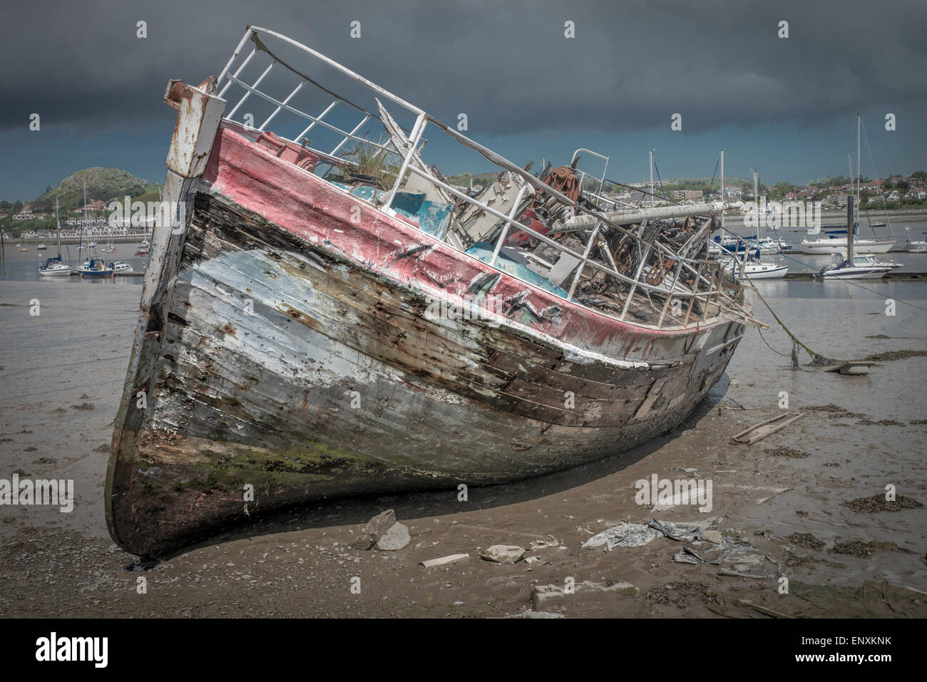 Abandoned decaying wooden boat beached on the shore of the River Conwy ...