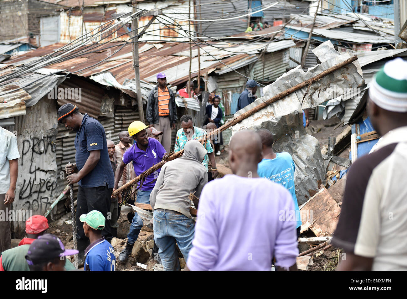 Nairobi, Kenya. 12th May, 2015. A rescuer removes debris at the site of ...
