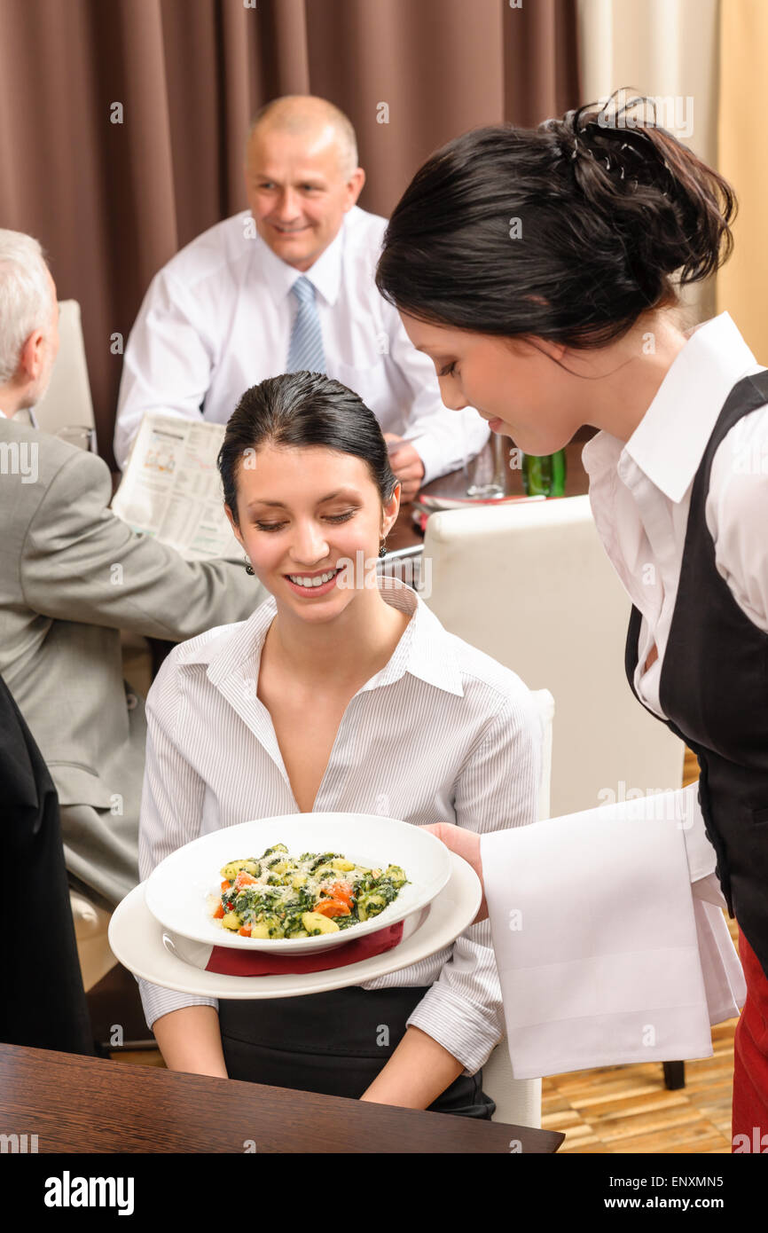 Business lunch restaurant waitress serving woman Stock Photo - Alamy