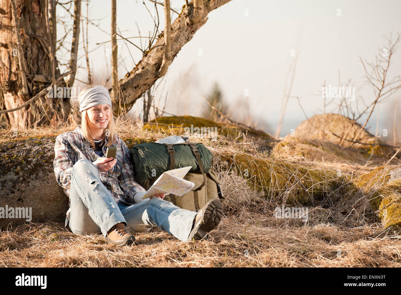 Camping young woman search navigation compass map Stock Photo - Alamy