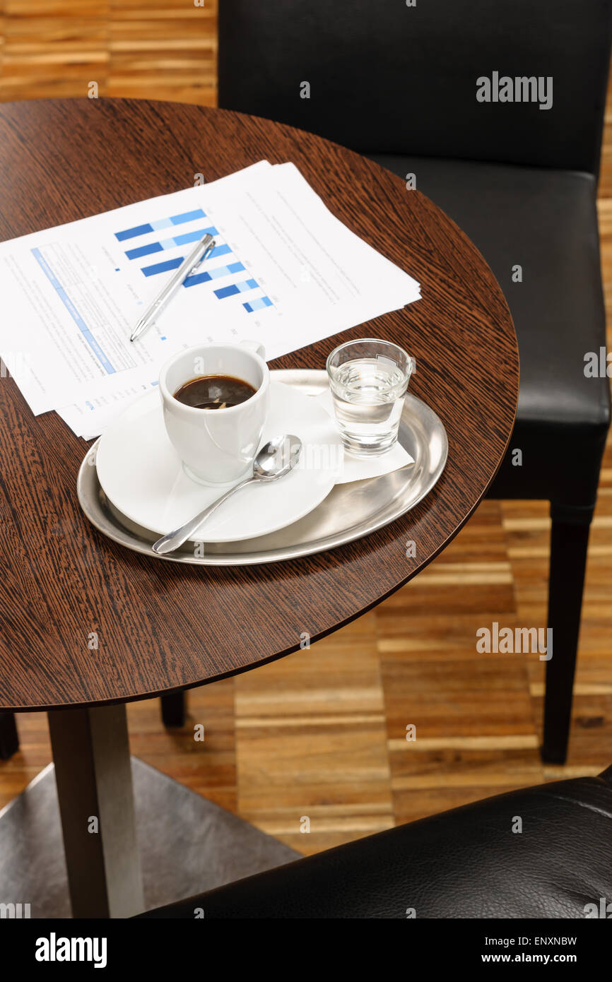 Coffee break business table with reports charts Stock Photo - Alamy