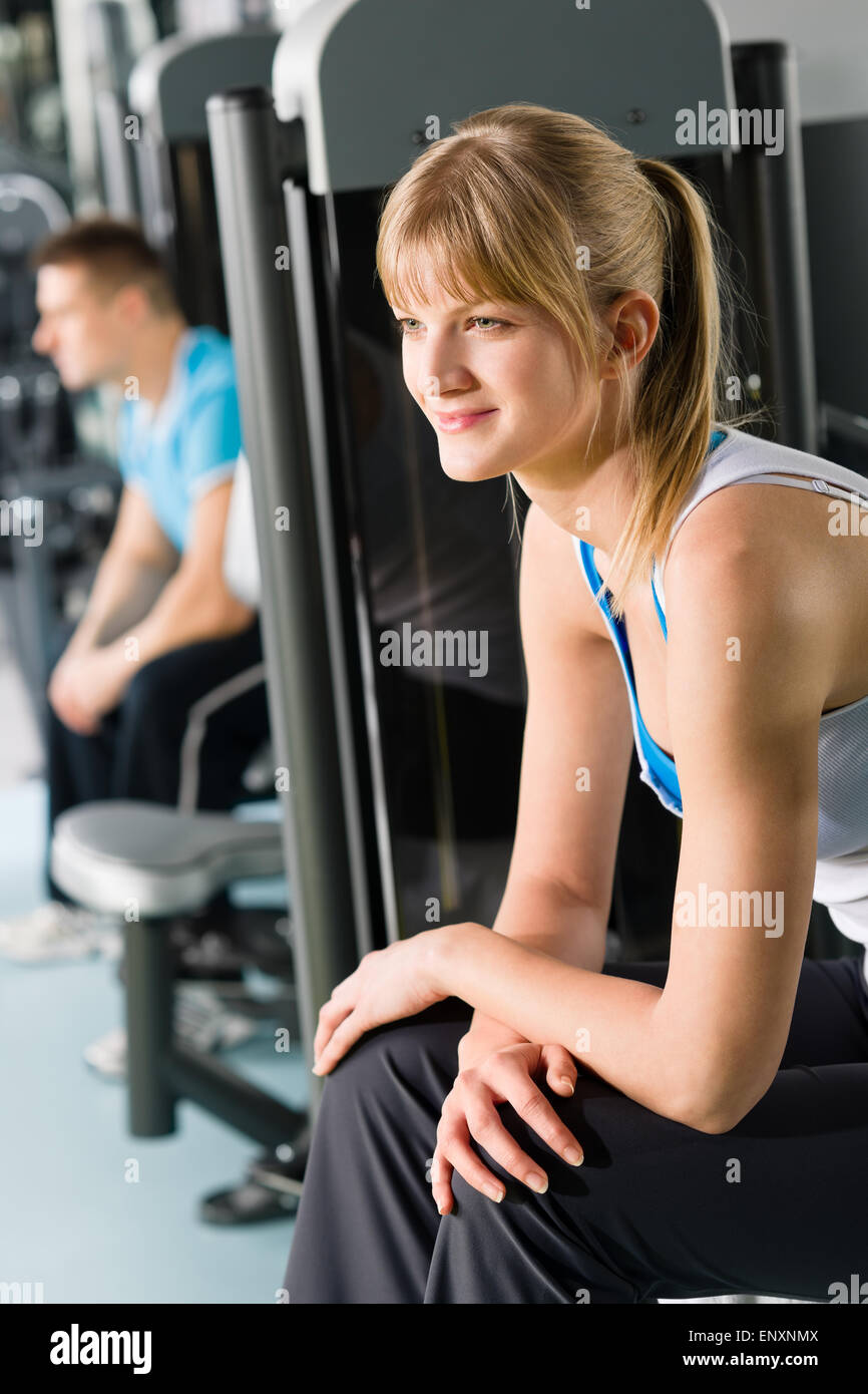 Two people at fitness center exercise machine Stock Photo - Alamy