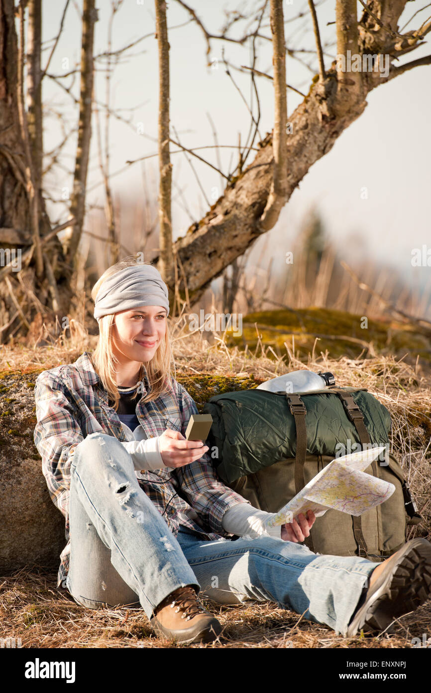 Camping young woman search navigation compass map Stock Photo - Alamy