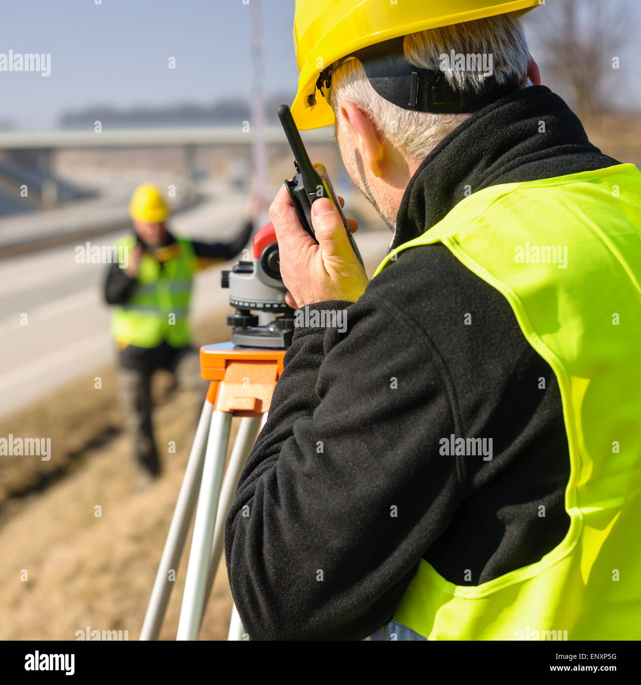 Geodesist measure land with tacheometer highway Stock Photo - Alamy