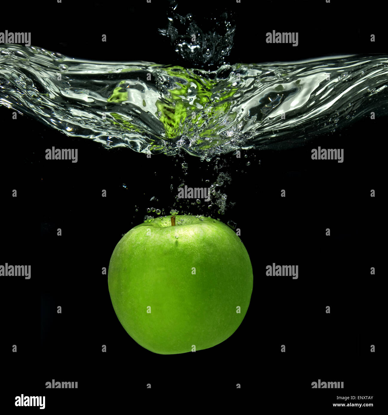 green apple dropped into water with splash isolated on black Stock ...