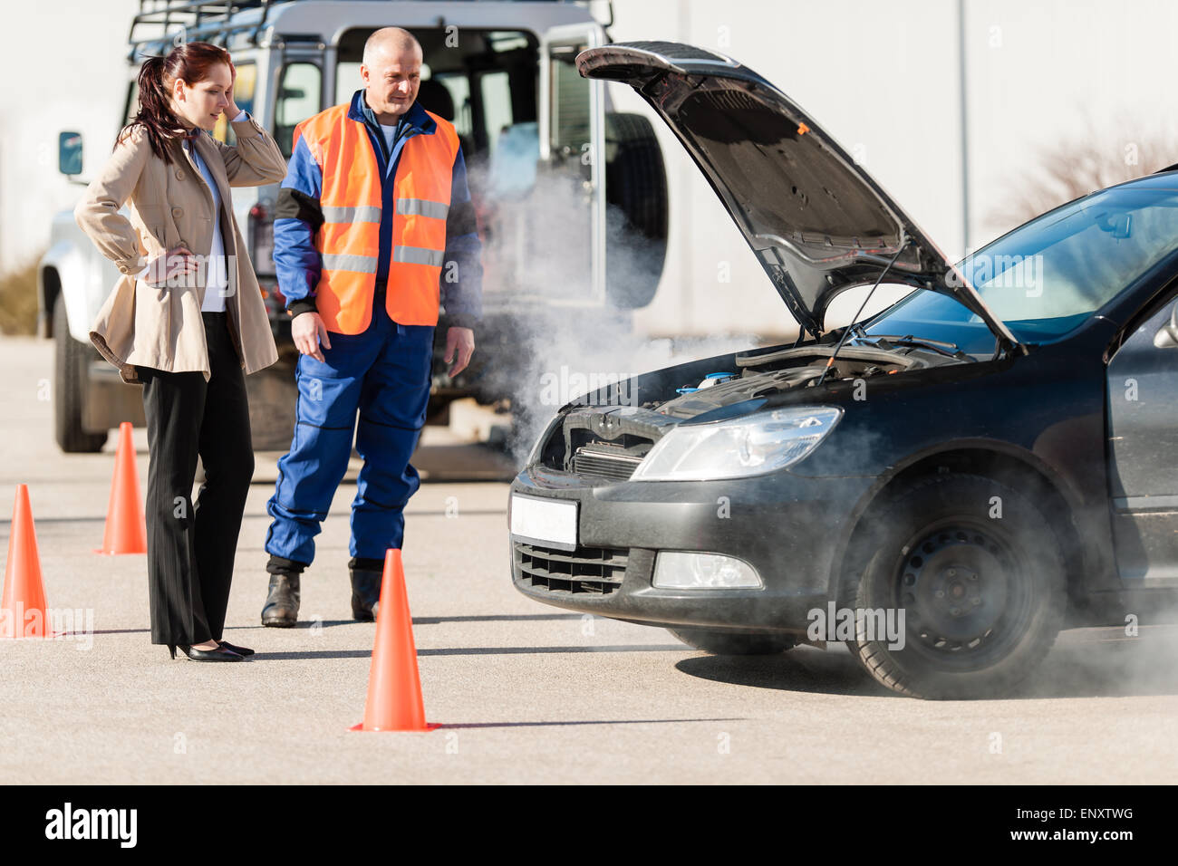 Woman with technician help smoking car engine Stock Photo - Alamy
