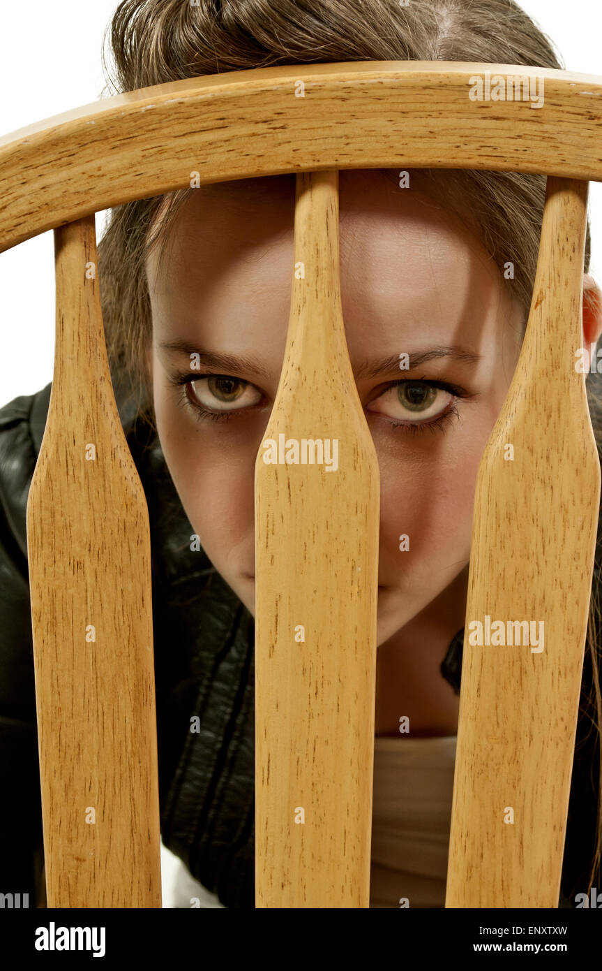 Woman Looking Through A Chair Stock Photo - Alamy