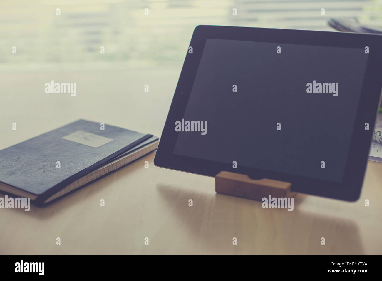 Tablet and notebook on a desk Stock Photo - Alamy
