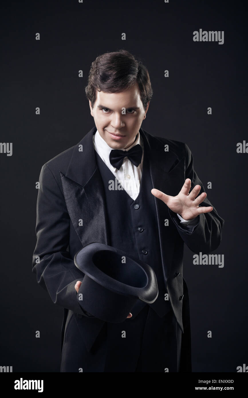 magician showing tricks with top hat isolated Stock Photo - Alamy