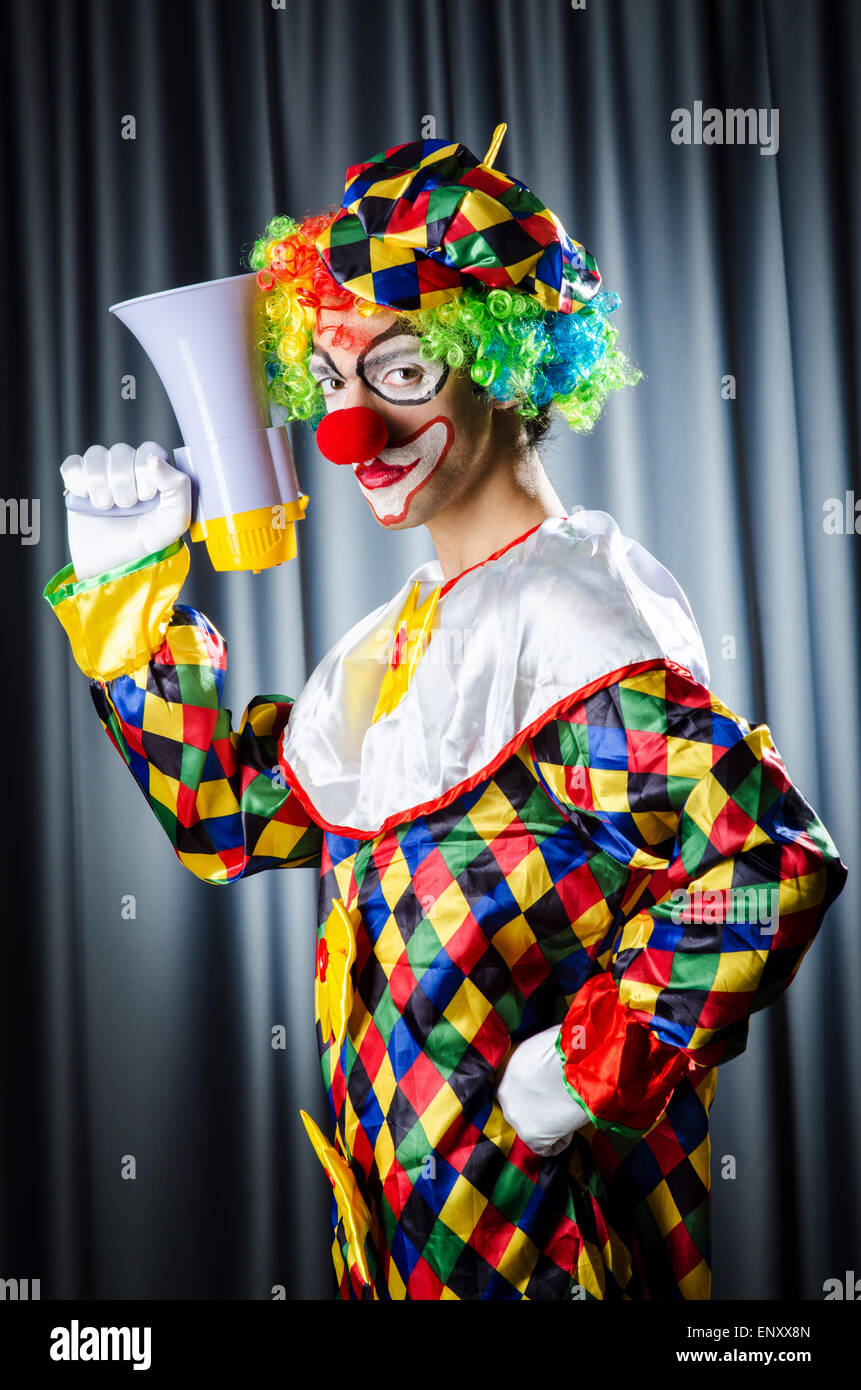Clown in studio with loudspeaker Stock Photo - Alamy