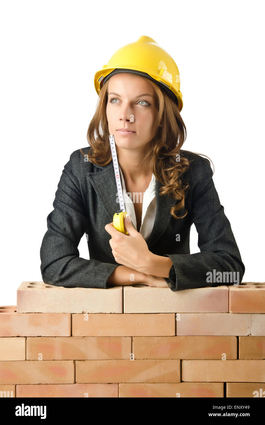 Young female builder near brick wall Stock Photo - Alamy