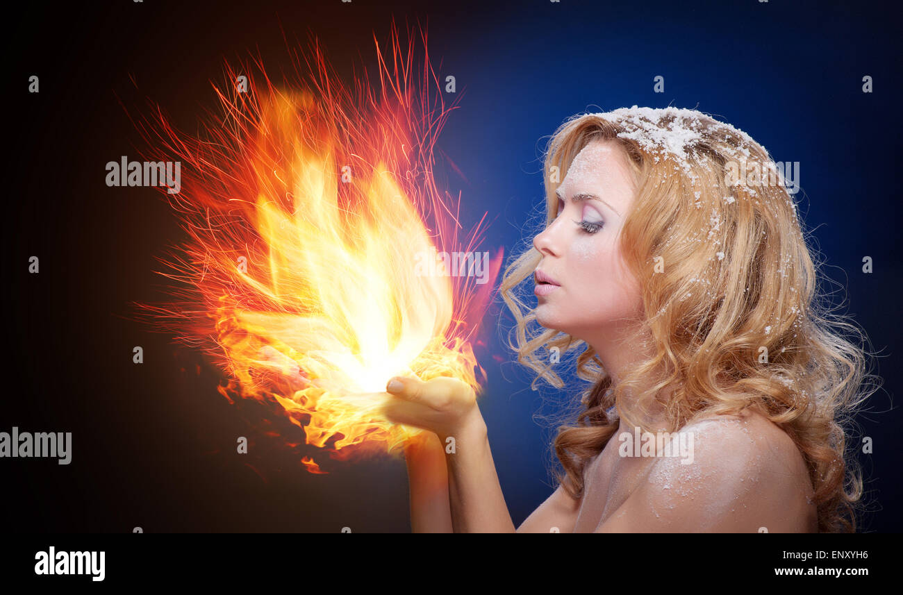Frozen girl hold a falme in palms (big flame Stock Photo - Alamy