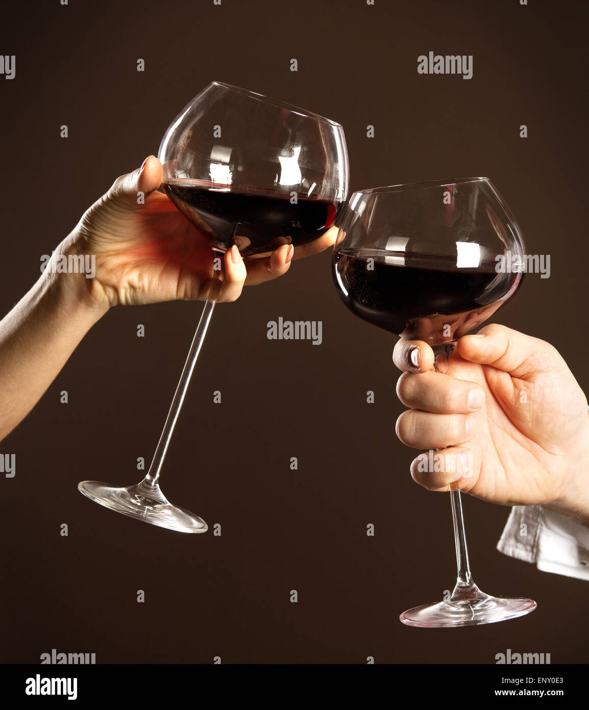 People holding glasses of white wine making a toast Stock Photo - Alamy