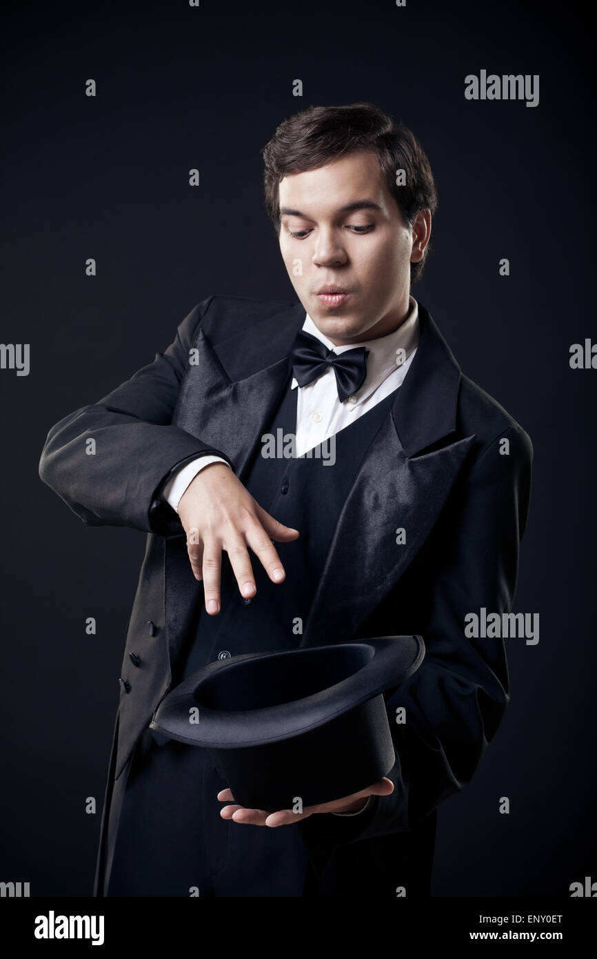 magician showing tricks with top hat isolated Stock Photo - Alamy