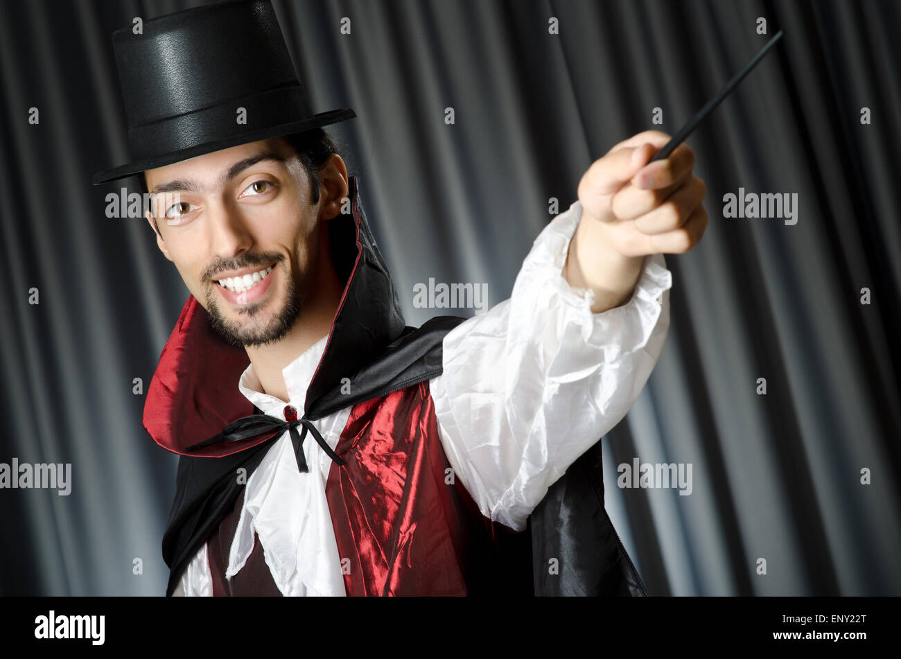 Magician doing tricks on white Stock Photo - Alamy