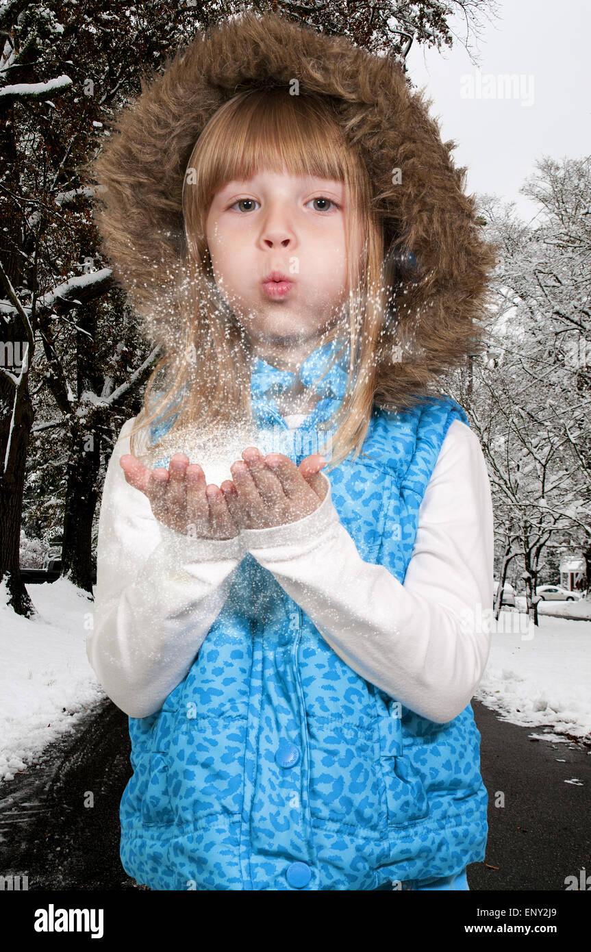 Girl Blowing Snow Stock Photo - Alamy