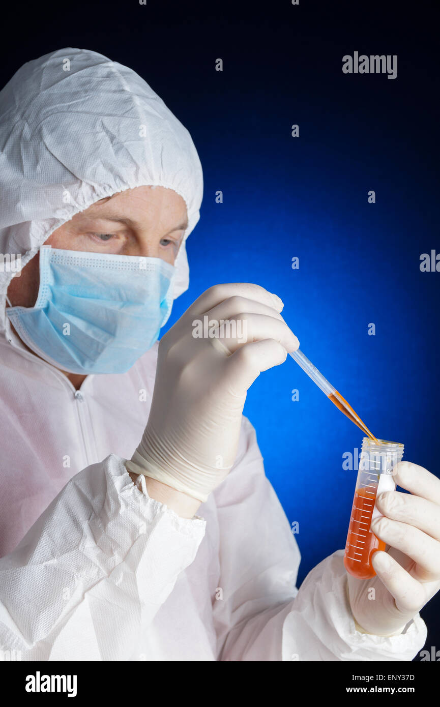 Lab worker in procetive suit and blue background Stock Photo - Alamy