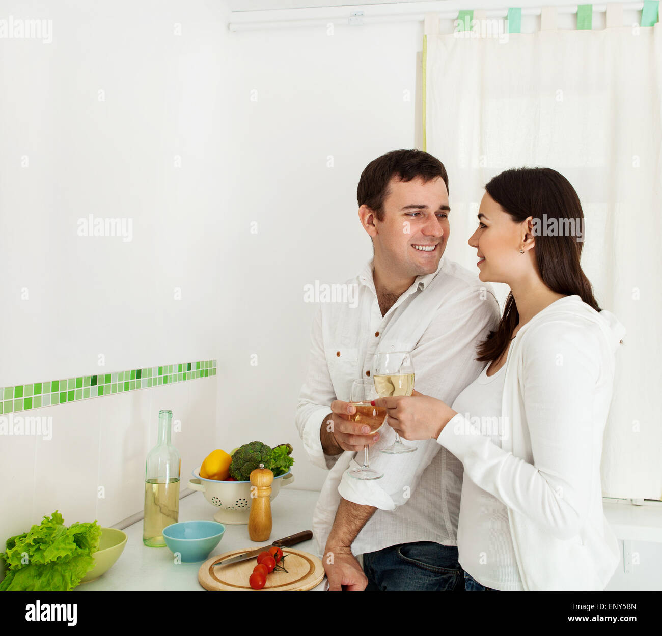 Portrait of a happy couple drinking white wine Stock Photo - Alamy
