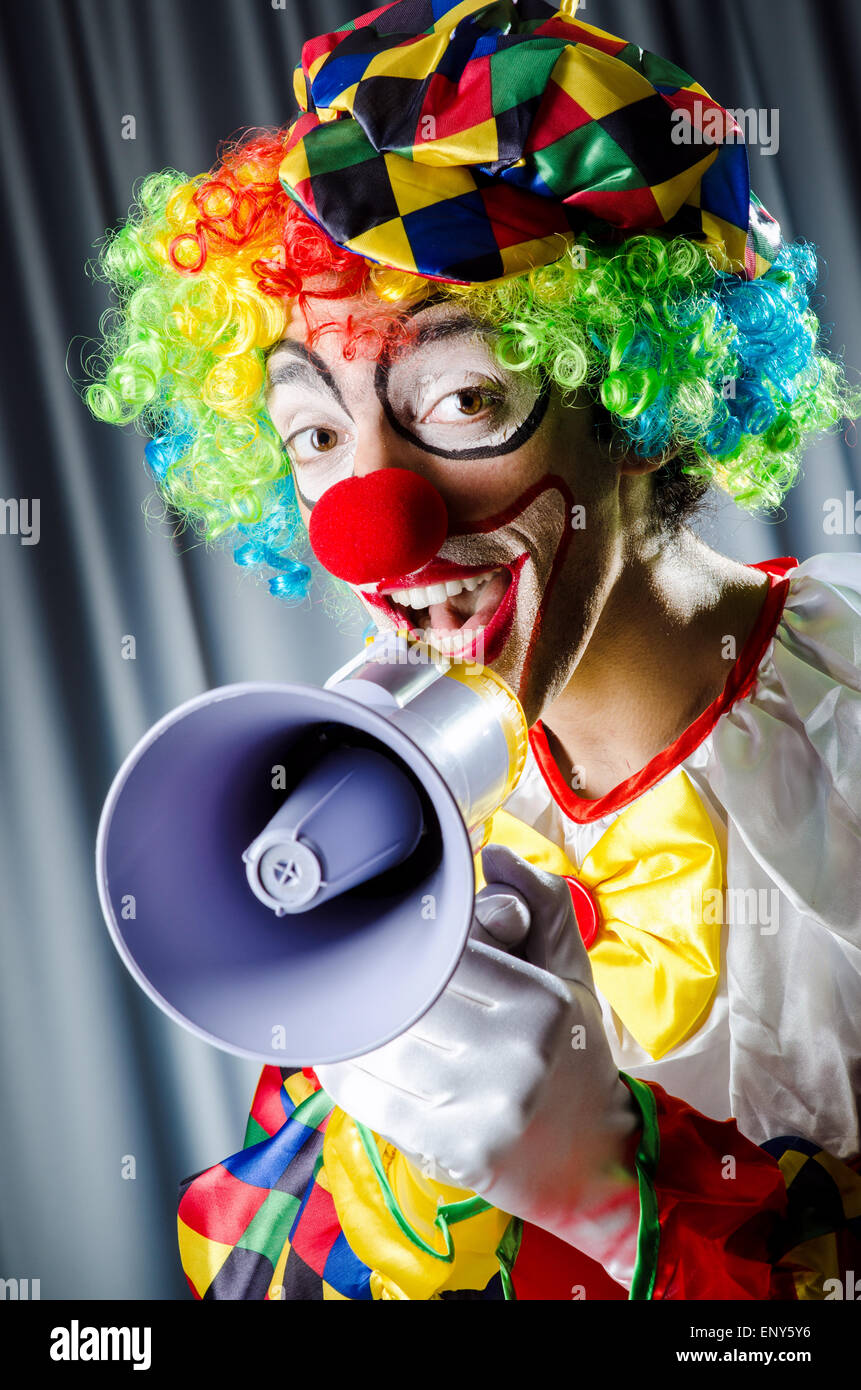 Clown in studio with loudspeaker Stock Photo - Alamy