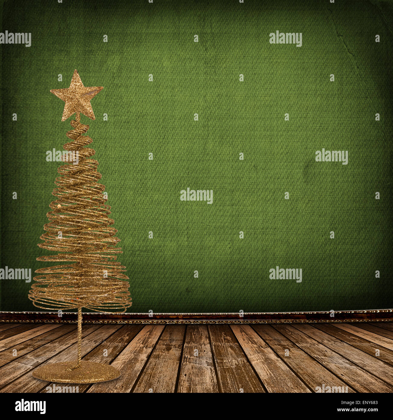 Christmas golden spruce in the old room, decorated with wallpaper Stock ...