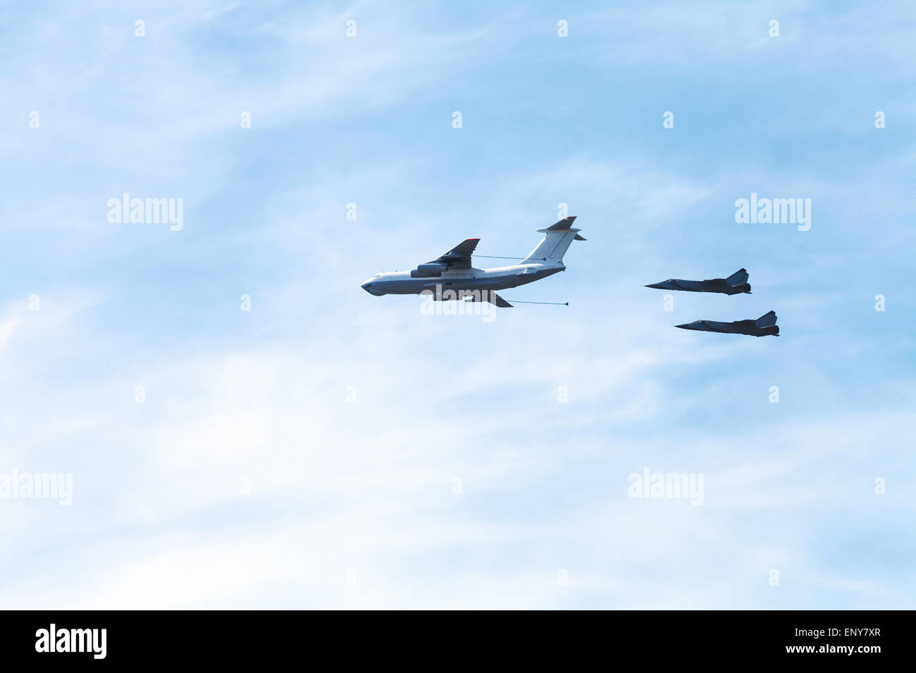 in-flight refueling of military fighter aircrafts in cloudy blue sky ...