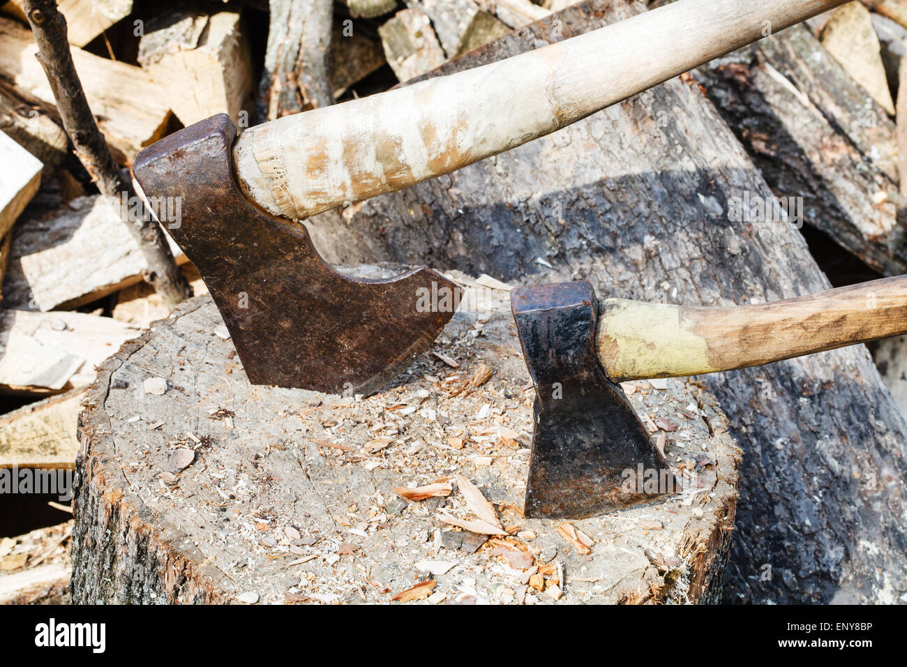 two axes in block for chopping firewood close up Stock Photo - Alamy