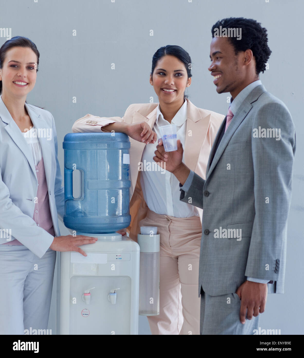 Business people with a water cooler in office Stock Photo - Alamy