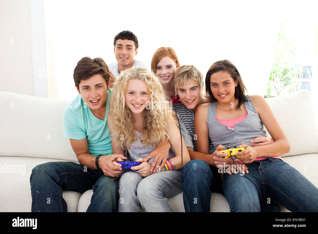 Teenagers playing video games in the living-room Stock Photo - Alamy