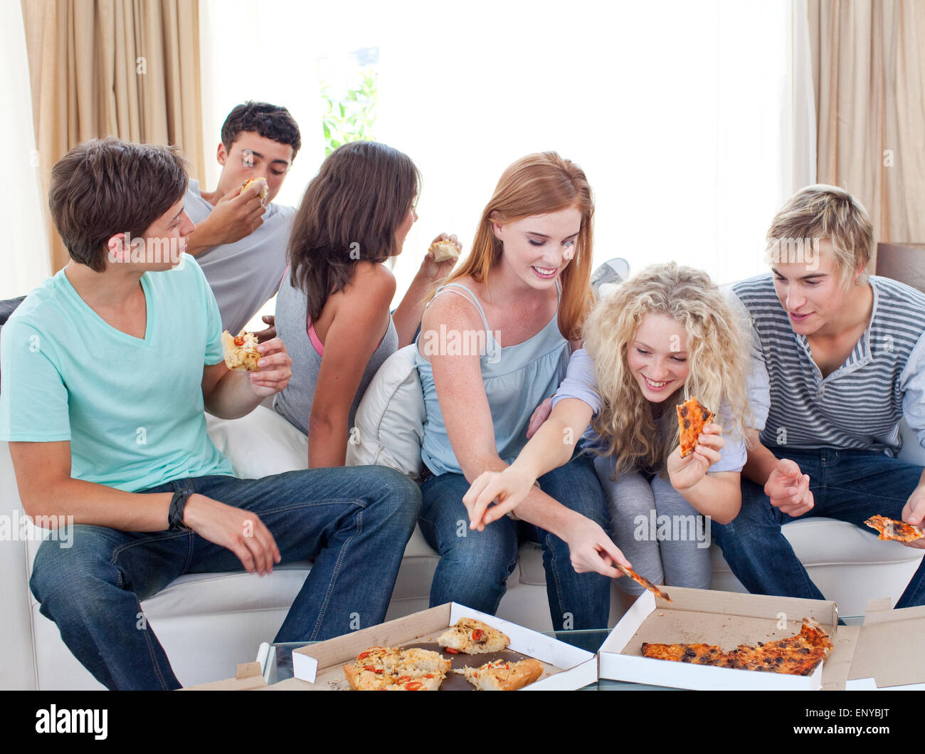Teenagers eating pizza at home Stock Photo - Alamy