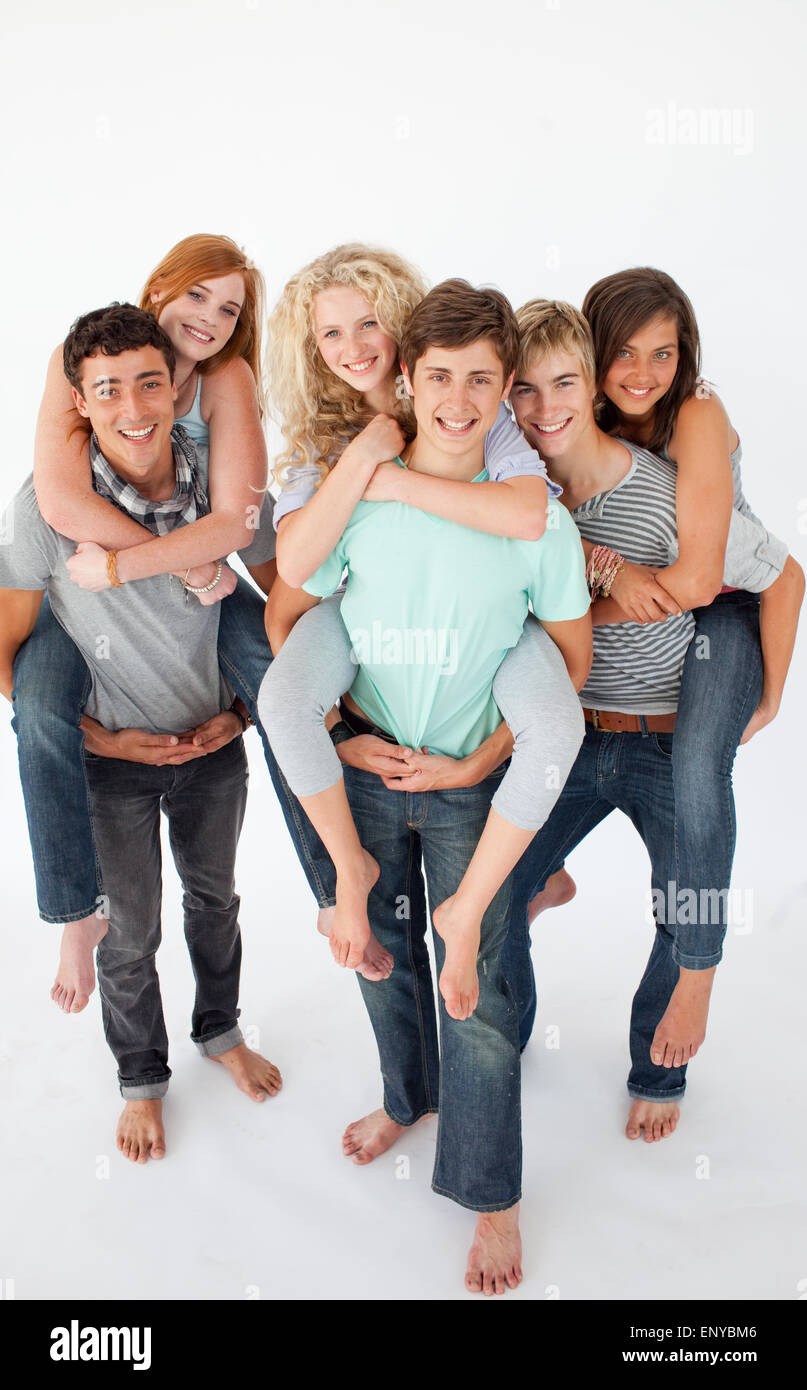 Teenagers giving their friends piggyback rides Stock Photo - Alamy