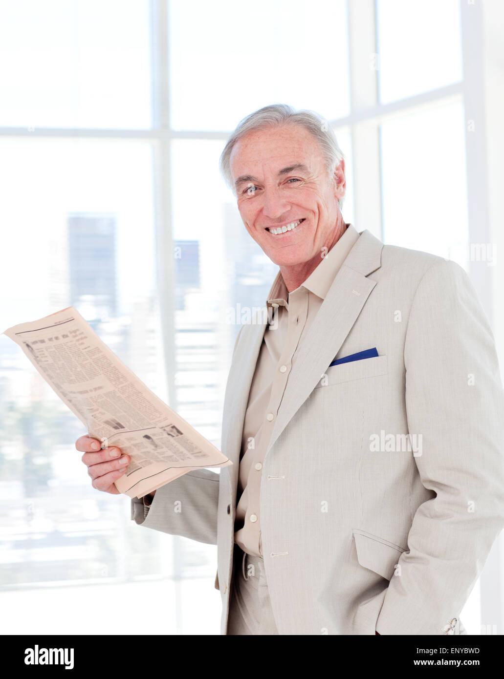 Portrait of a smiling manager reading newspaper Stock Photo - Alamy