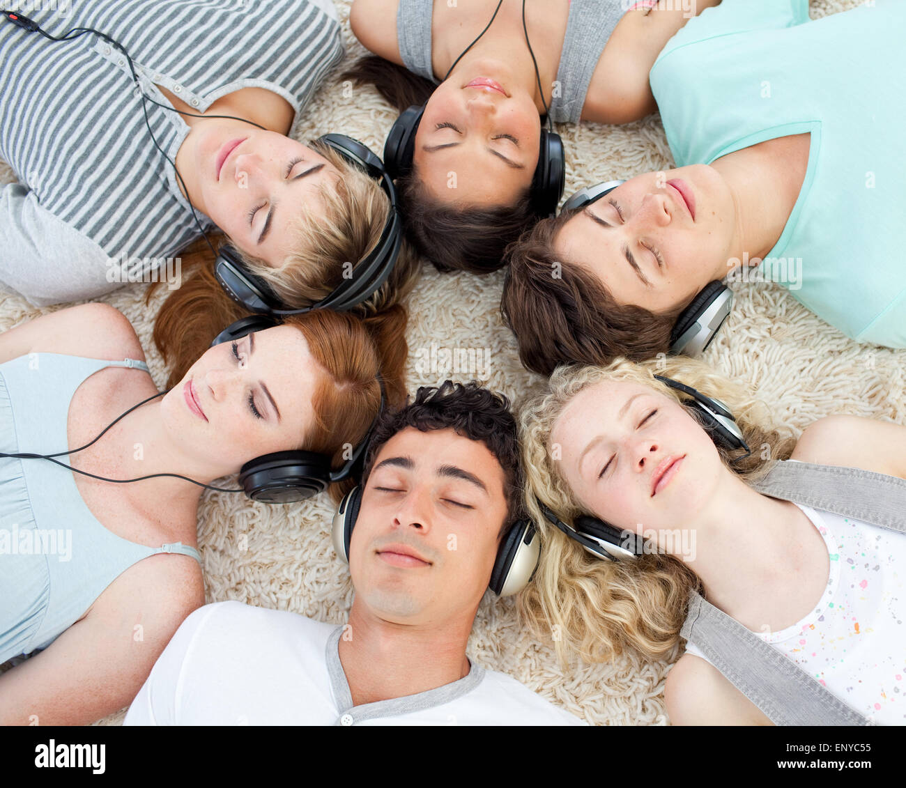 Group of friends listening to music on the floor Stock Photo - Alamy