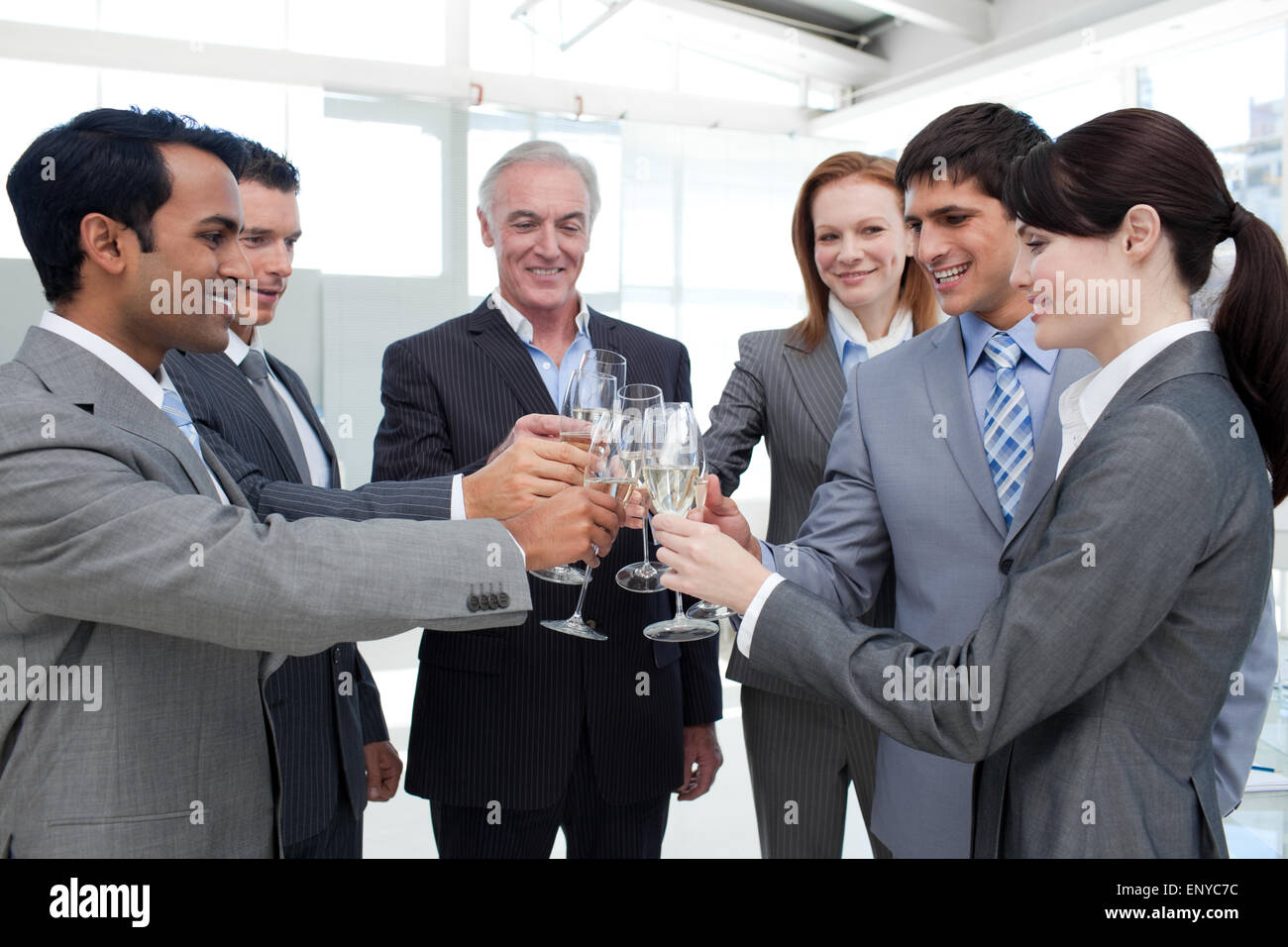 Cheerful business team toasting with Champagne Stock Photo - Alamy