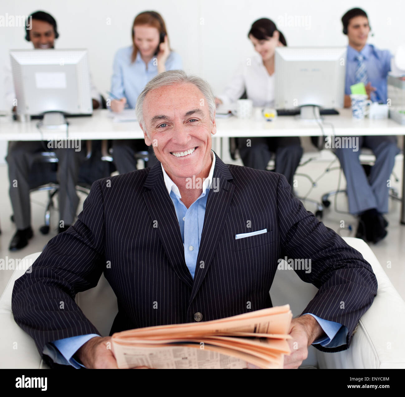 Senior manager reading a newspaper Stock Photo - Alamy