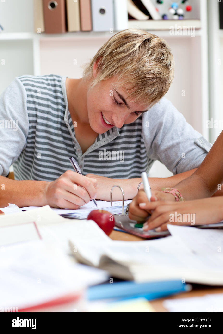 Teen guy studying in the library Stock Photo - Alamy