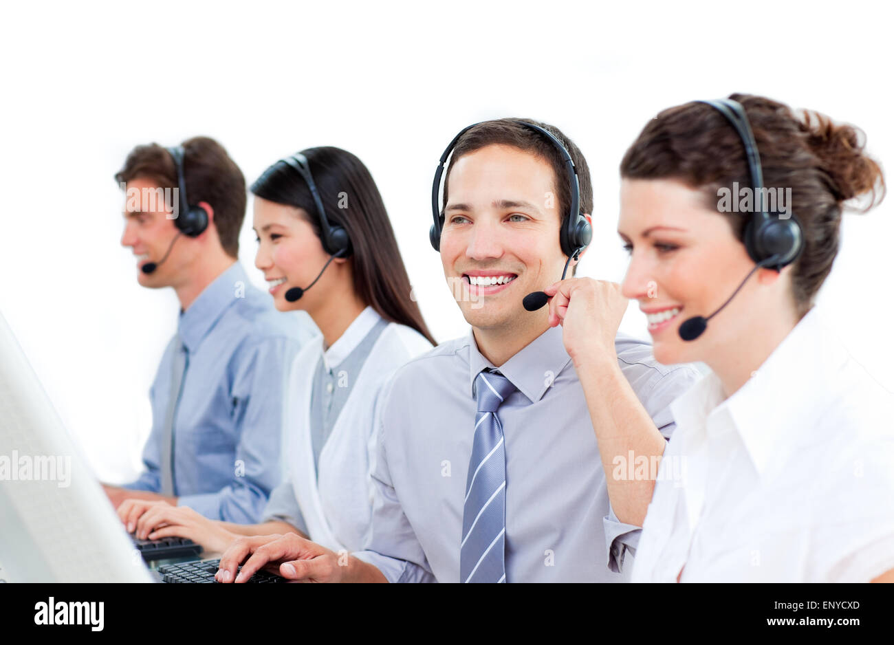 Multi Ethnic Customer Service Agents Working In A Call Center Against A