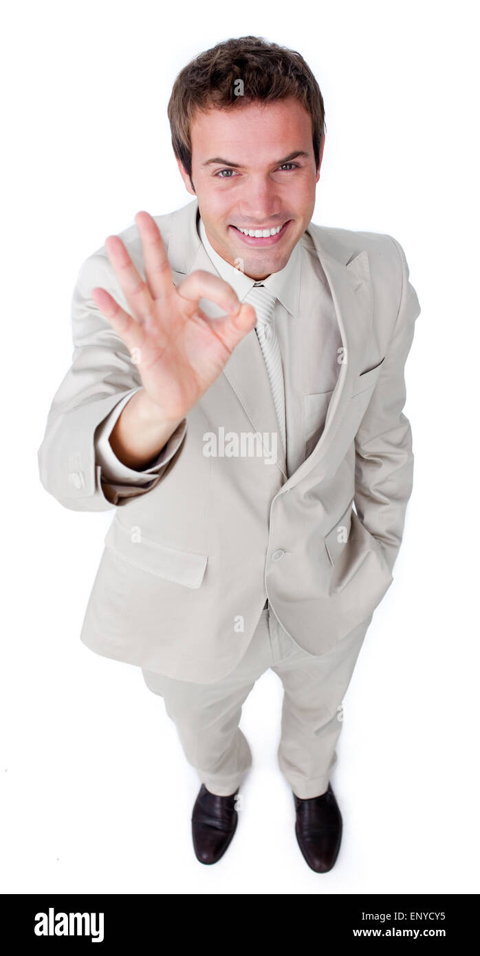 Fortunate businessman showing OK sign isolated on a white background ...