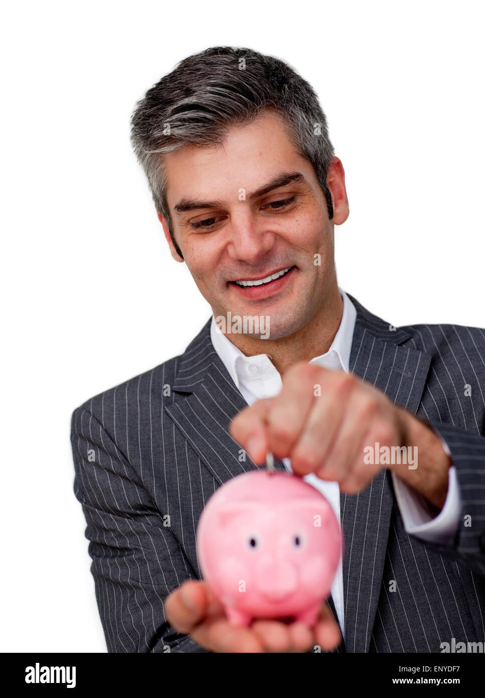 Assertive Businessman saving money in a piggybank against a white ...