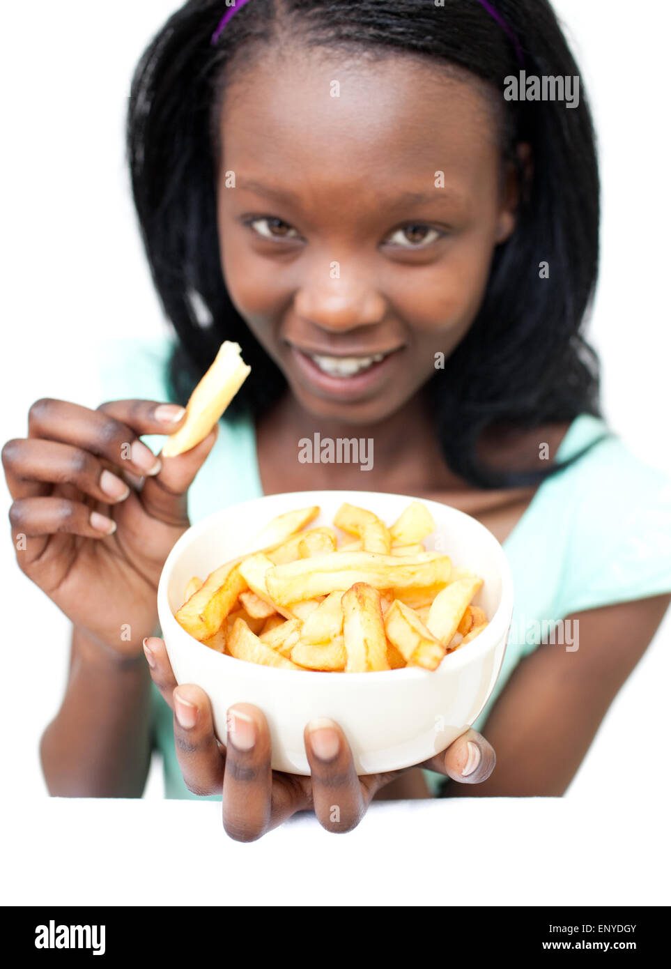 Attractive young woman eating fries Stock Photo - Alamy