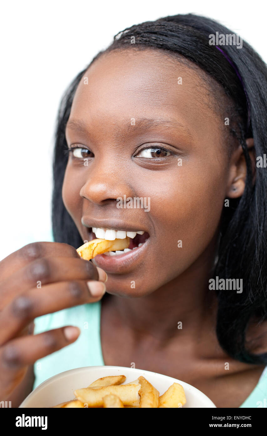 Cheerful young woman eating fries Stock Photo - Alamy