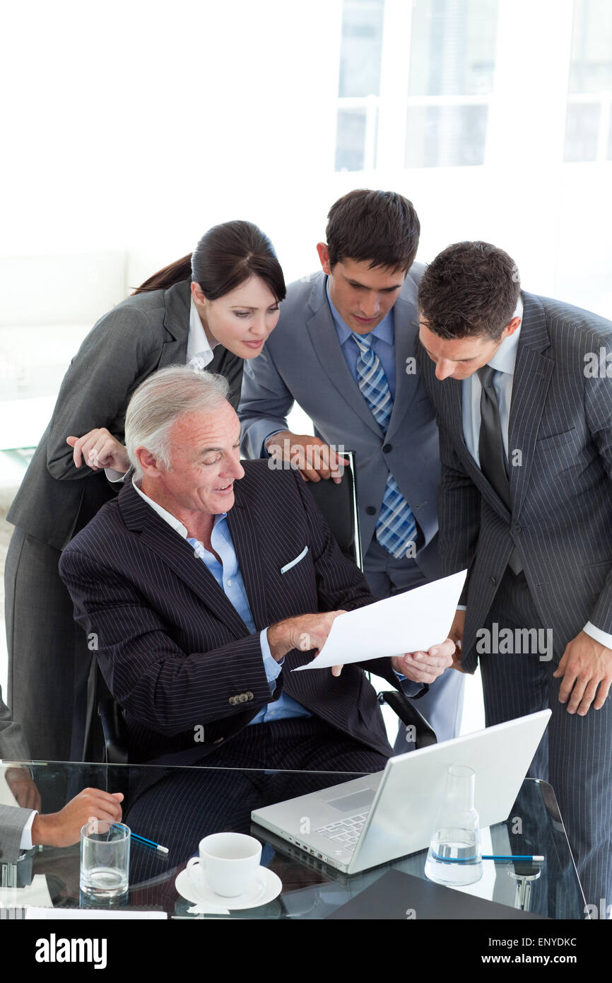 Manager showing document to his team Stock Photo - Alamy