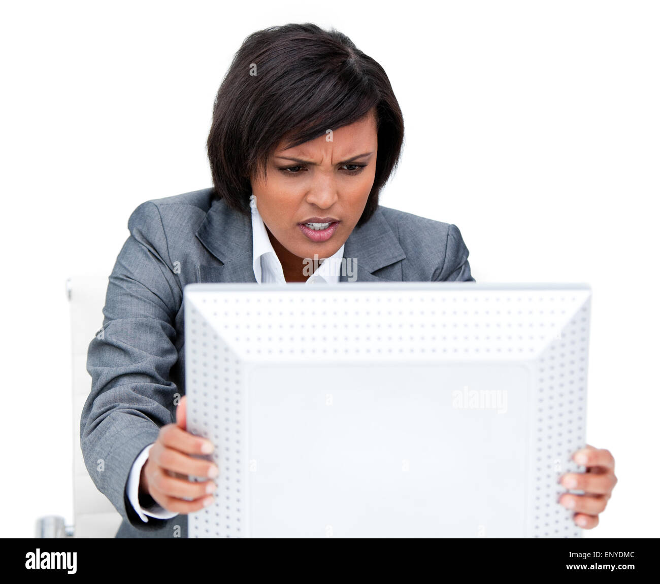 Frustrated businesswoman shaking her computer's screen in the office ...