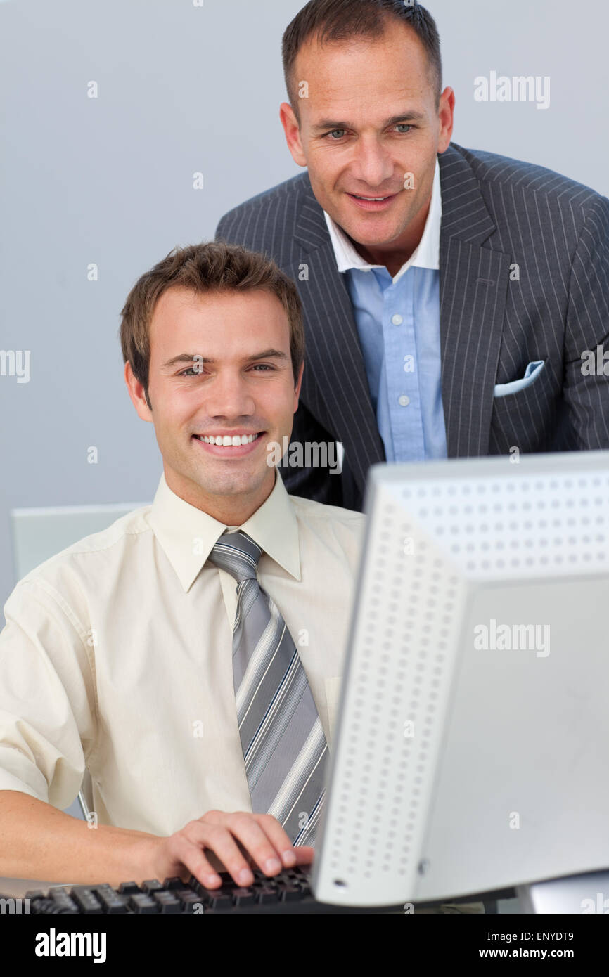 Attractive manager checking his employee's work Stock Photo - Alamy