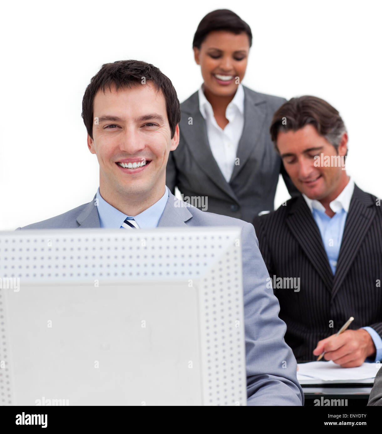 Portrait of a businessman and his team working at a computer Stock ...