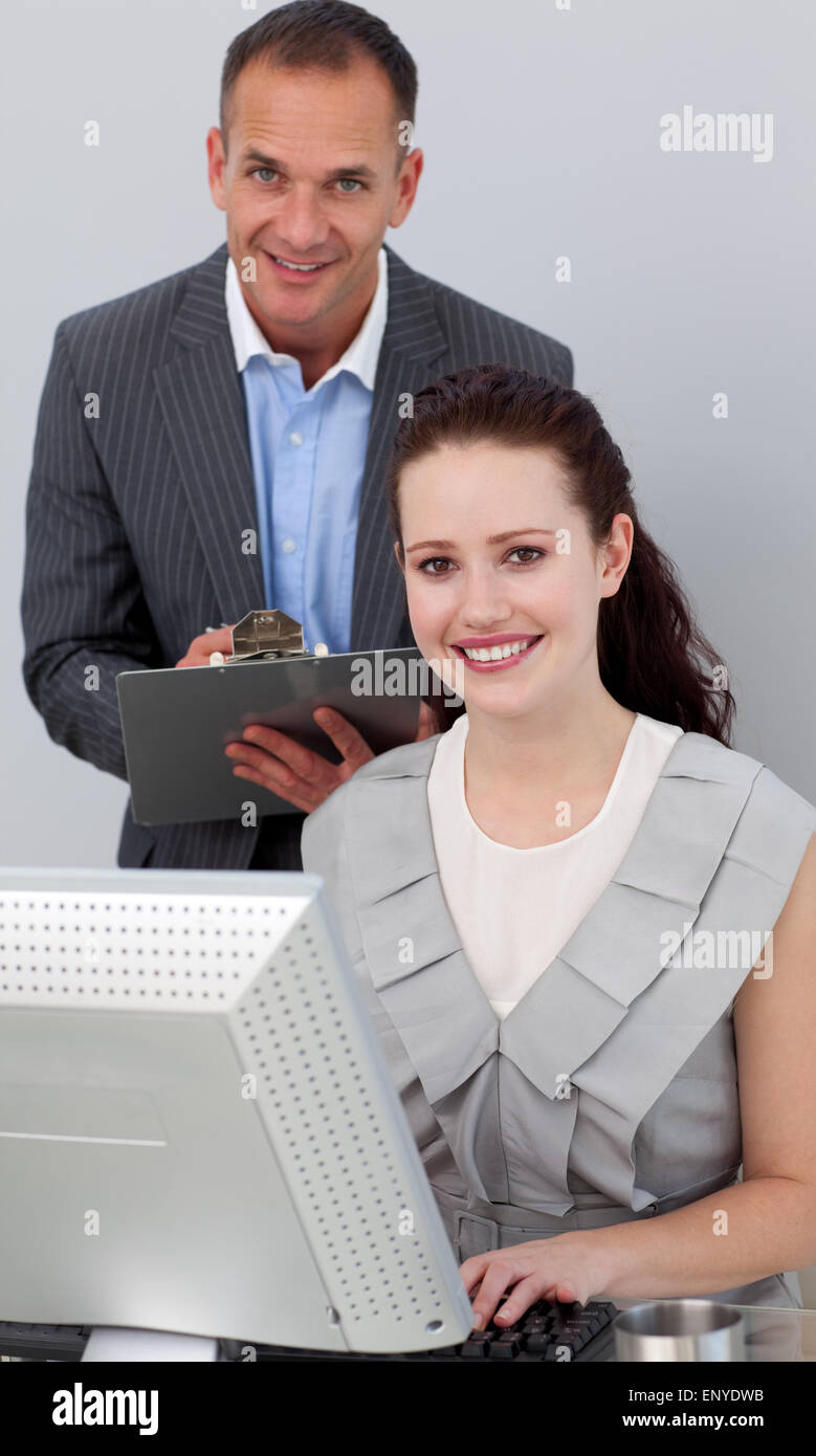 Charismatic manager and his employee smiling at the camera Stock Photo ...